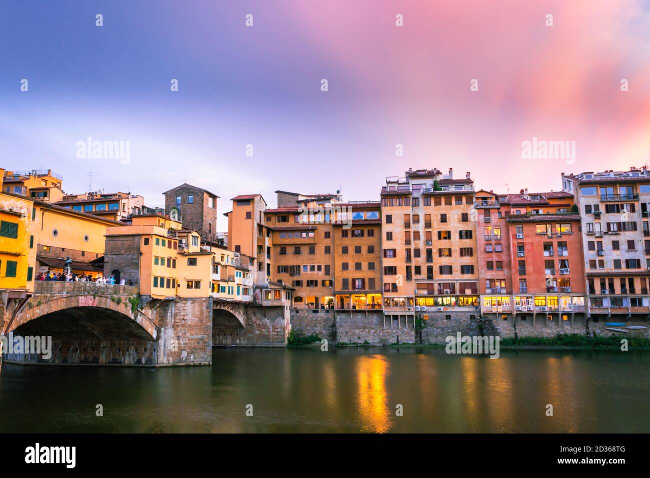 View with a unique perspective of the Ponte Vecchio with the river Arno and colorful buildings ...