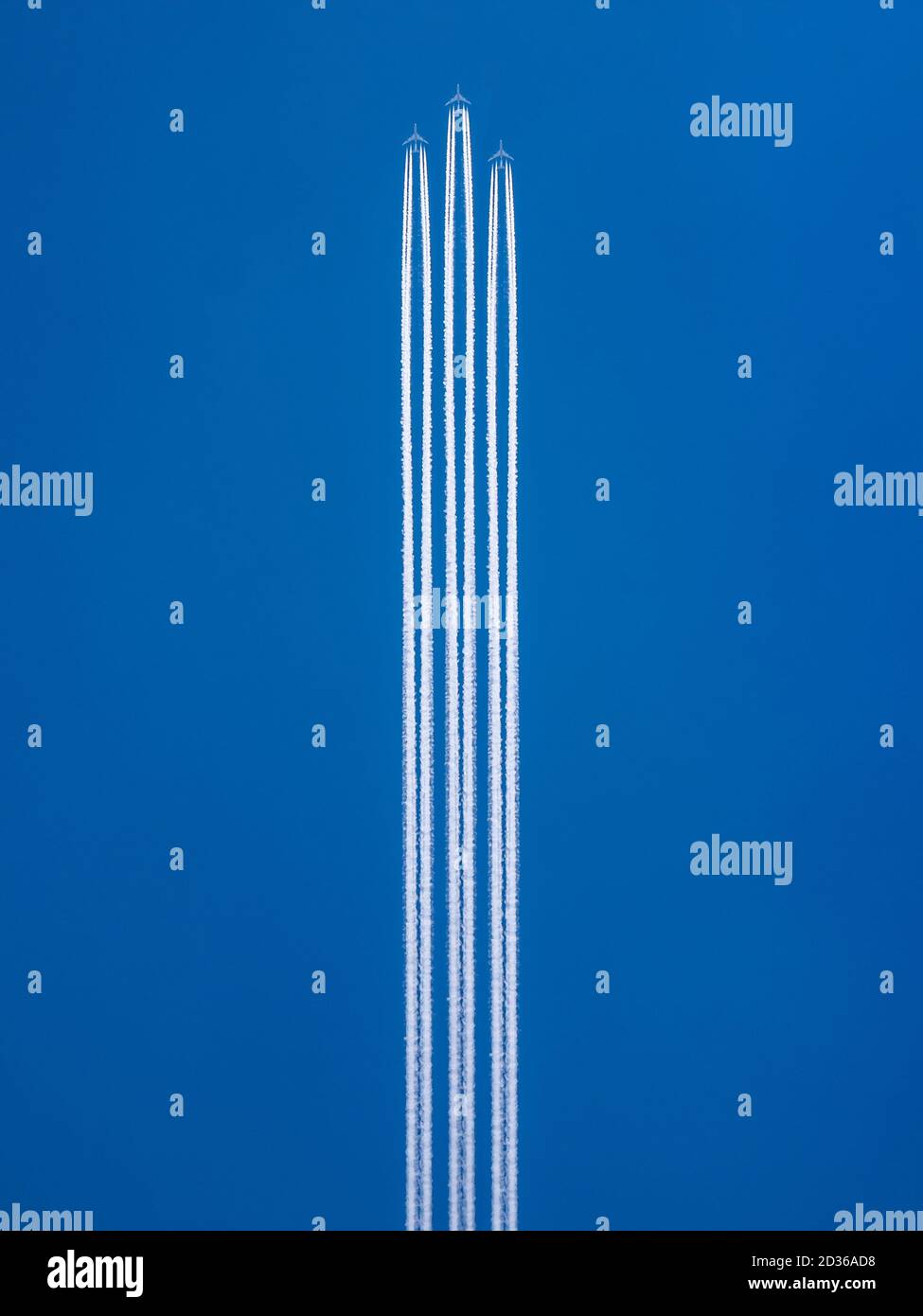Three planes in formation in the blue sky with a condensation trails ...