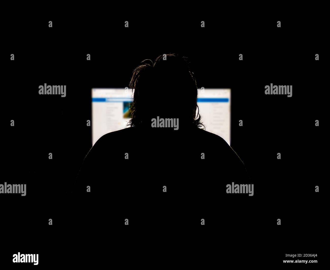 The outline of the person in front of the monitor at night Stock Photo ...