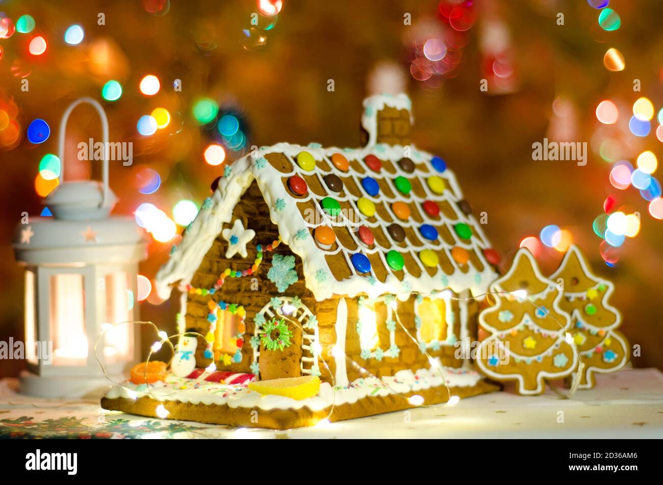 gingerbread house with garland lights and lantern Stock Photo - Alamy