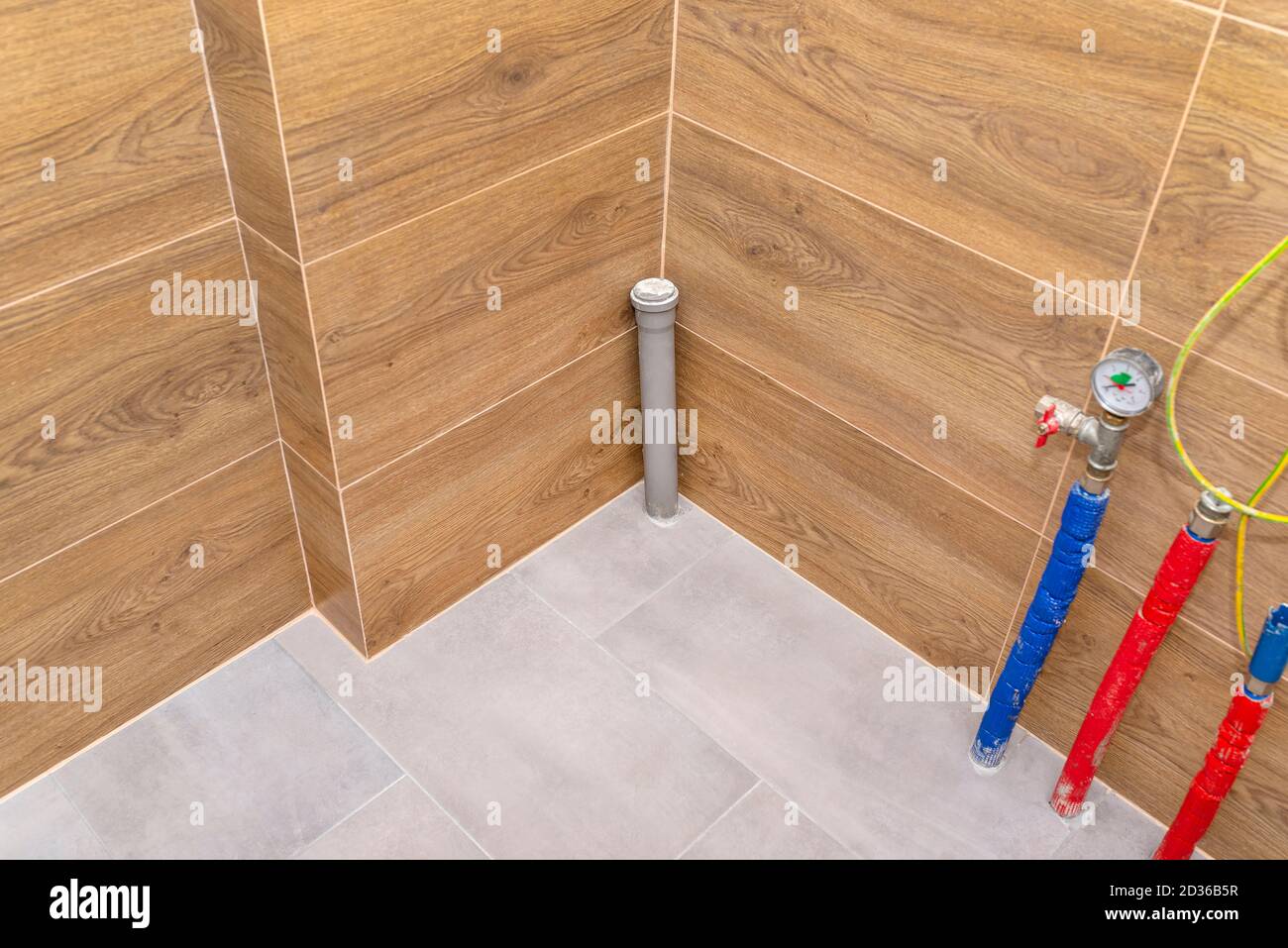 Sewer pipe coming out of the floor in the corner of the room in a ...