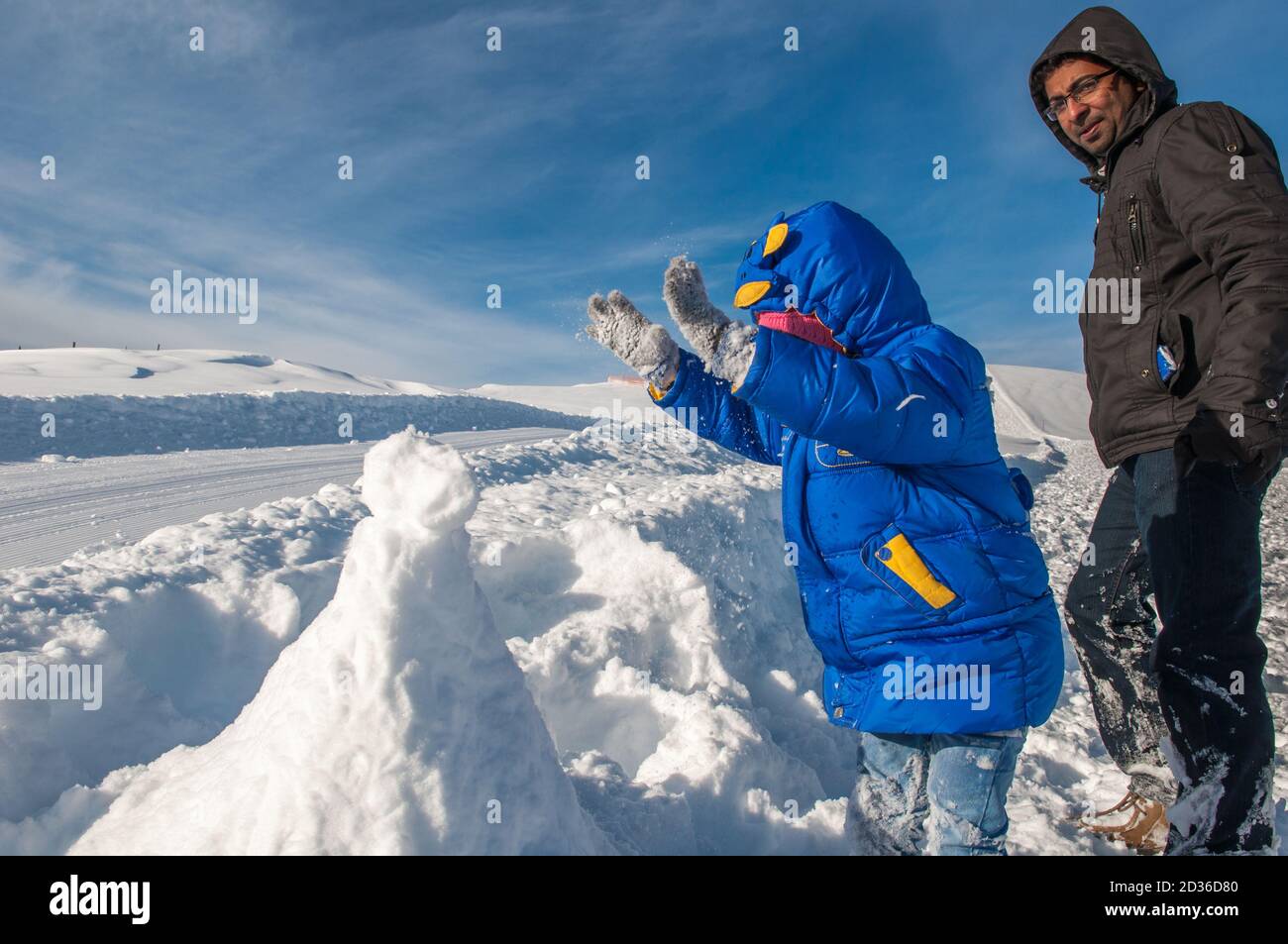 Happy Indian family playing with fresh white snow in Switzerland Shimla ...