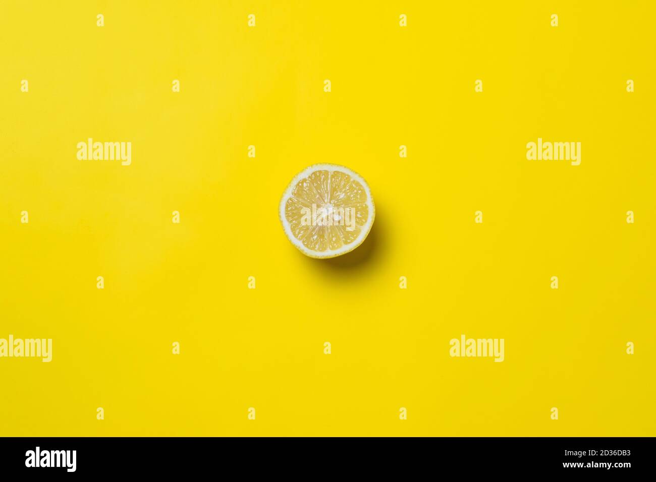 Top view of a split lemon on yellow background with an empty space for ...