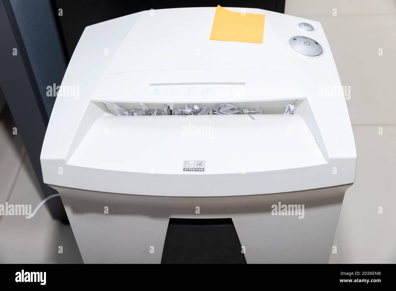 Top view of document shredder with papers overflowed from inside the ...