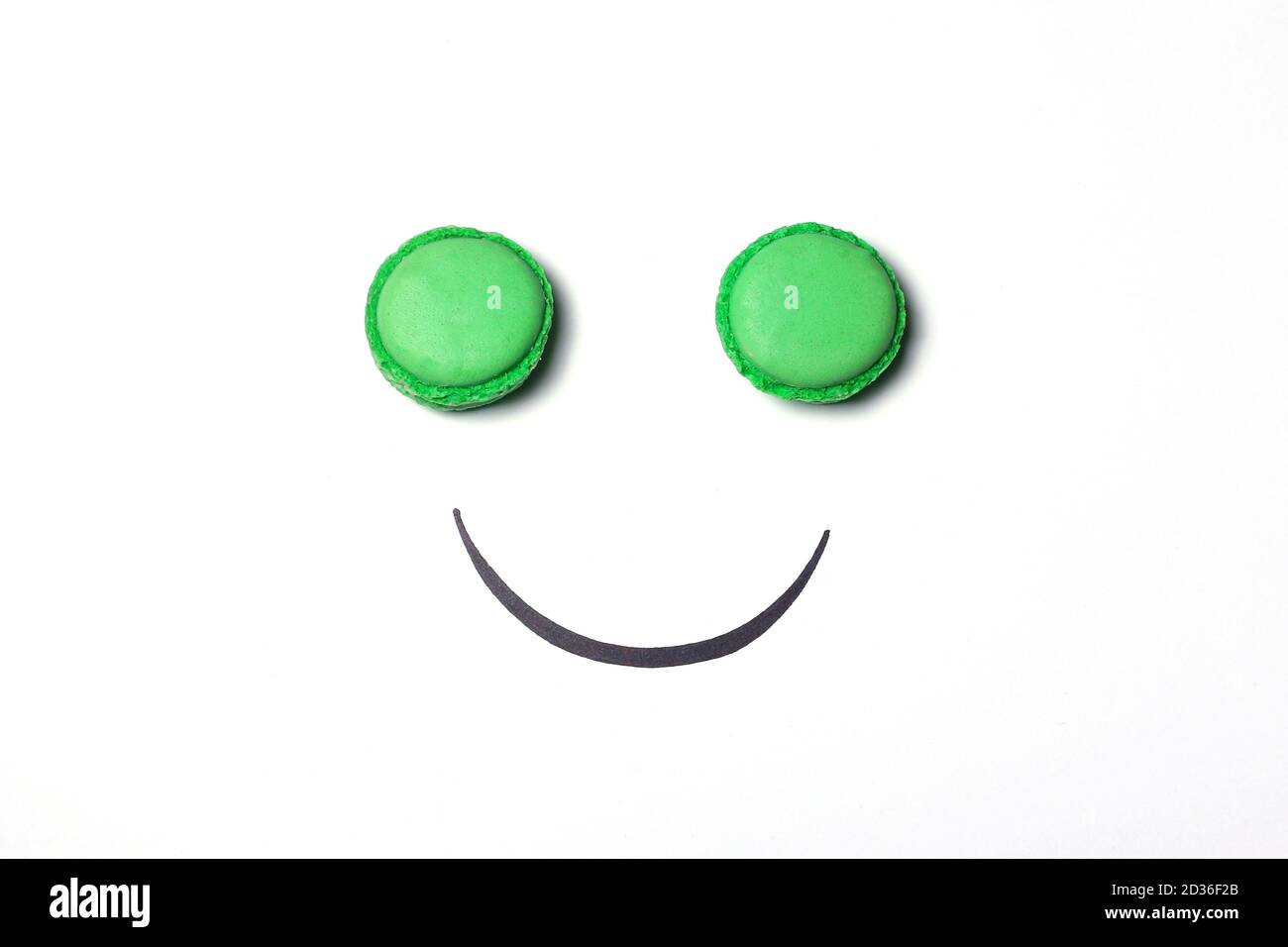 Smiley face concept. Smiley face made from macaroon on white background ...