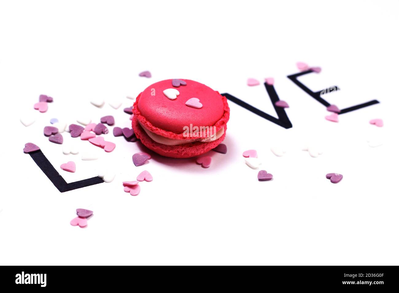 Love. Pink macaroon and hand drawn letters with little hearts. Sweet ...