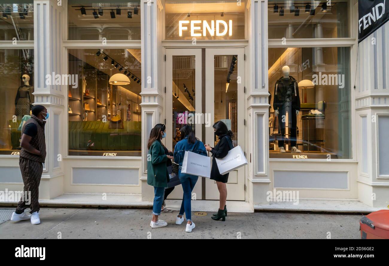 Shoppers wait to enter the Fendi store in Soho in New York on Sunday ...