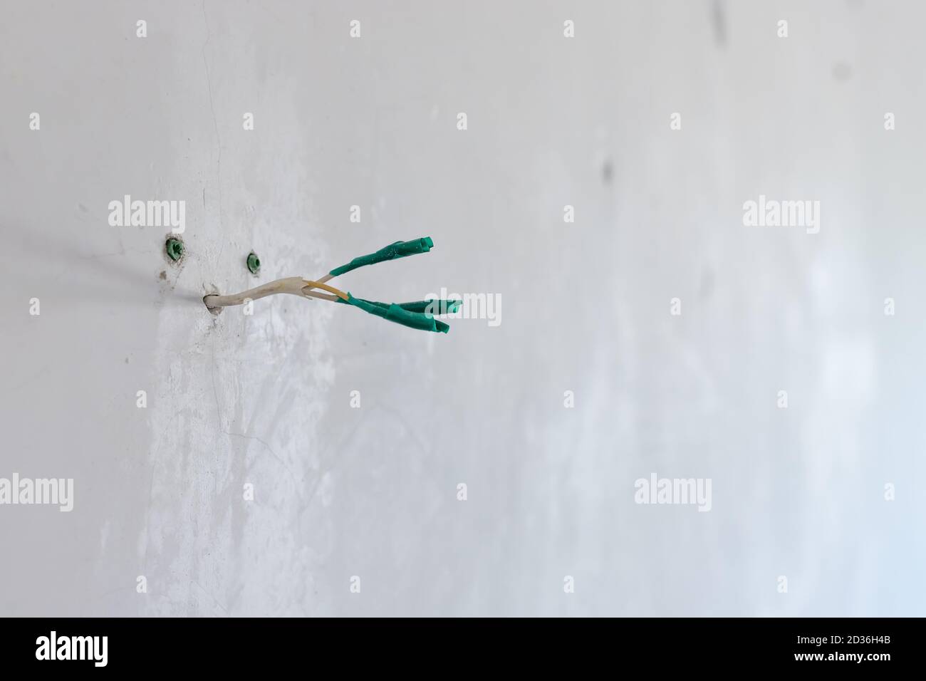 three insulated electrical wires on a white plastered wall Stock Photo ...