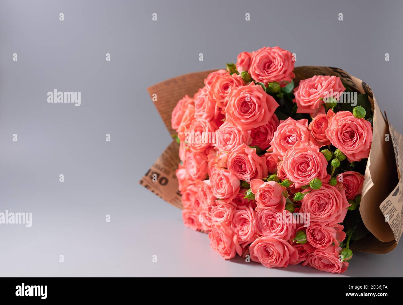beautiful bouquet of pink roses wrapped in craft paper Stock Photo - Alamy