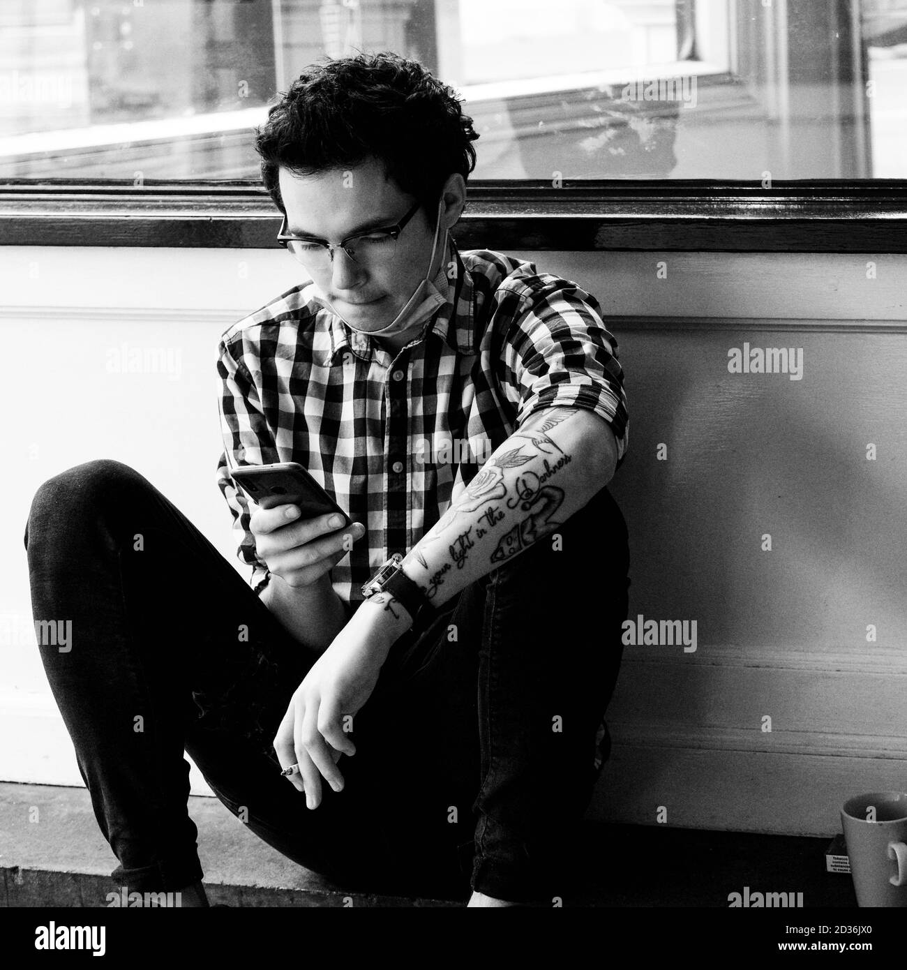 Man squatting smoking cigarette smoking Black and White Stock Photos ...