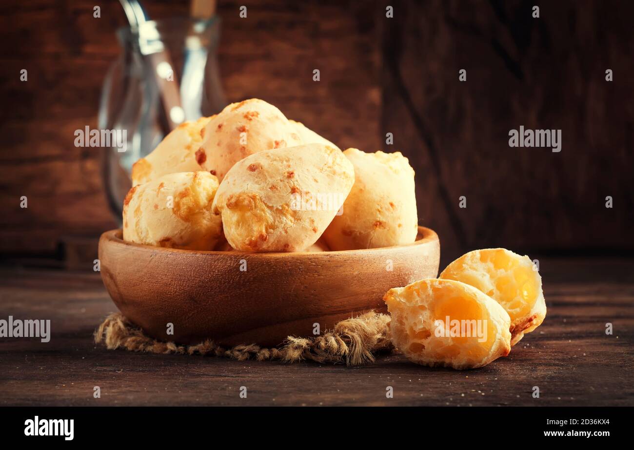 Cheese buns in wooden bowl, rustic kitchen table background, copy space ...