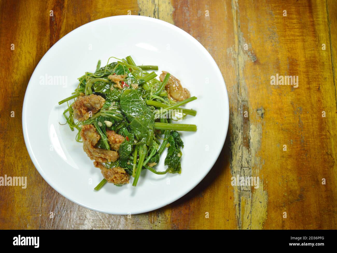 fried Chayote sprout with crispy chicken on plate Stock Photo - Alamy