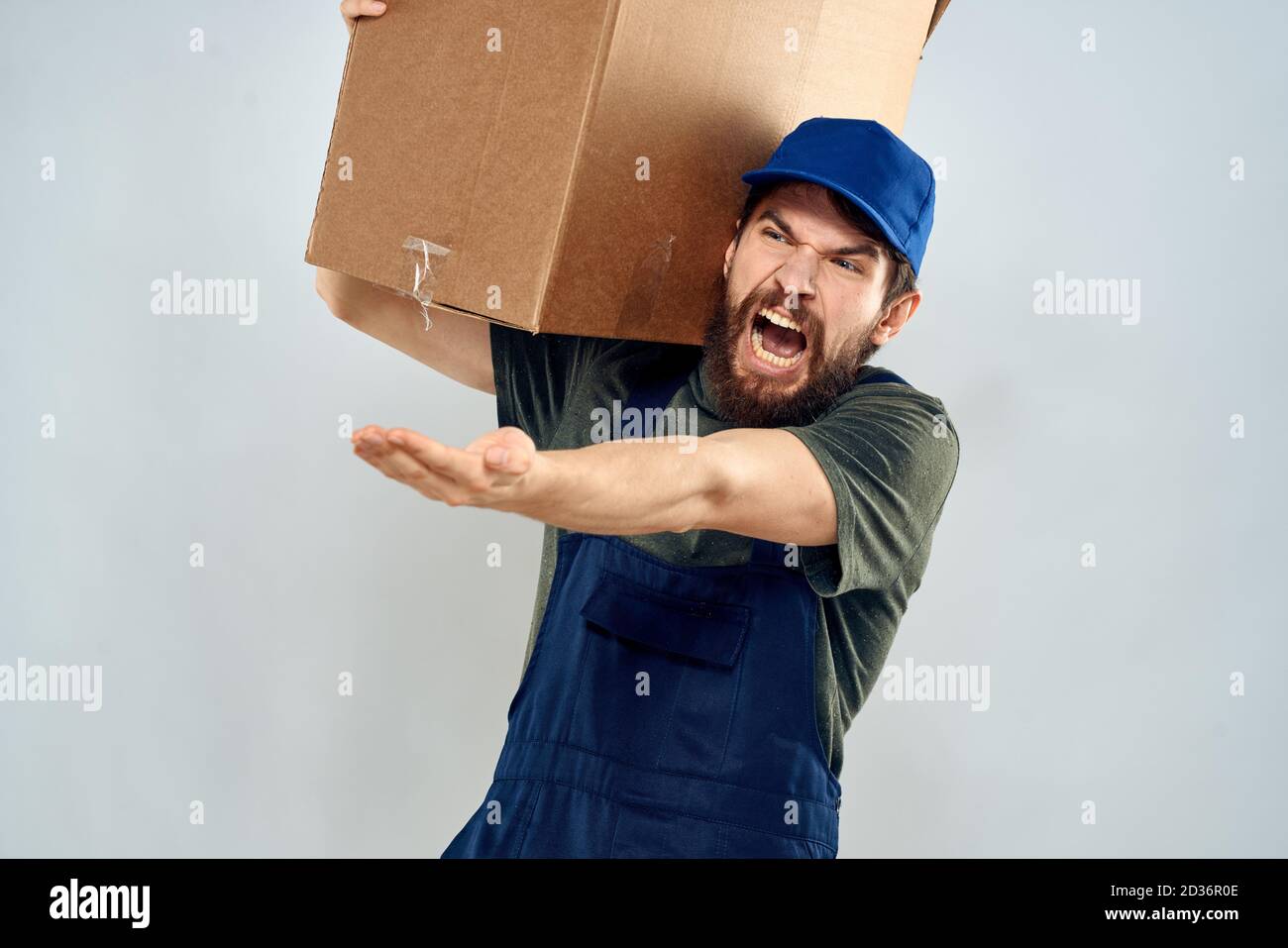 Male worker loading delivery boxes in hands packing lifestyle Stock ...