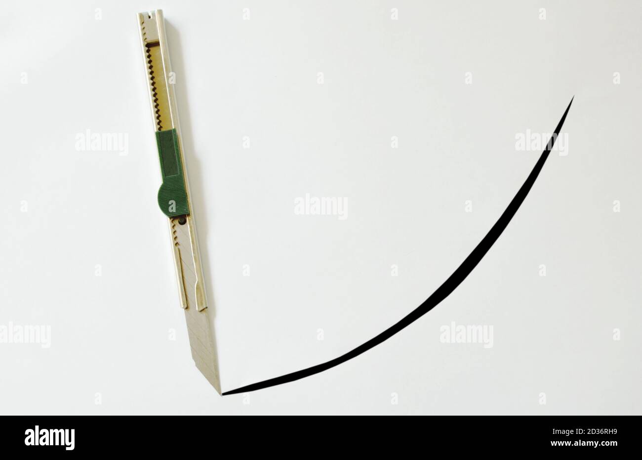 cutter blade curve slashing on white paper background Stock Photo - Alamy