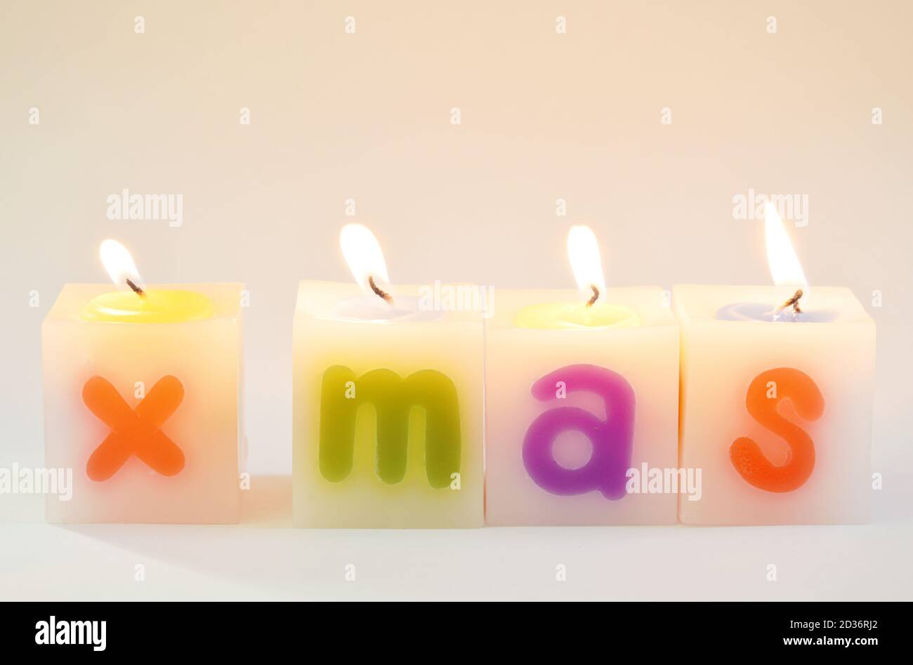 candle fire arranging X Mas word on white background Stock Photo - Alamy