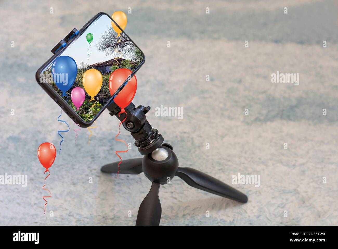 colorful balloons and mobile phone on tripod Stock Photo - Alamy