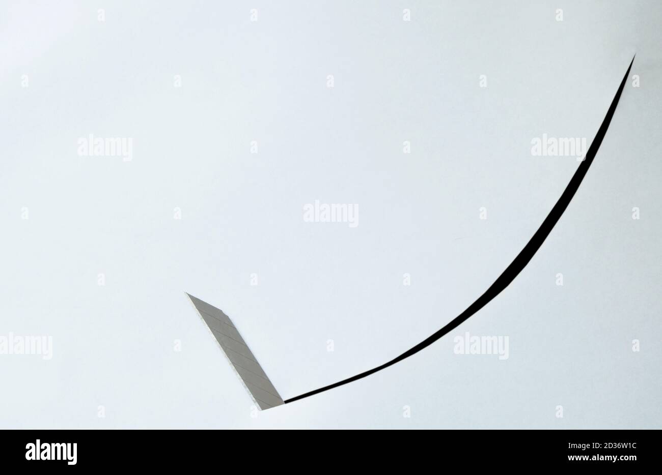 cutter blade curve slashing on white paper background Stock Photo - Alamy