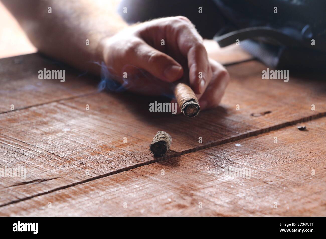 Hand holding and smoking a cigar in a tobacco farm in Vinales Cuba ...