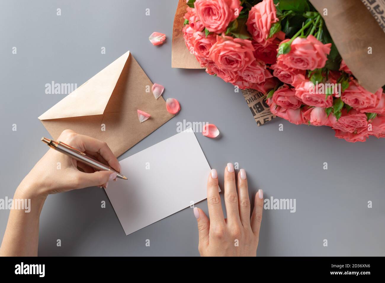 left-handed woman writing greeting card Stock Photo - Alamy