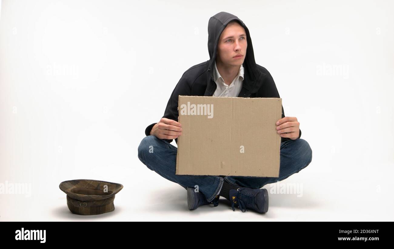 Young begging man with blank cardboard Stock Photo - Alamy