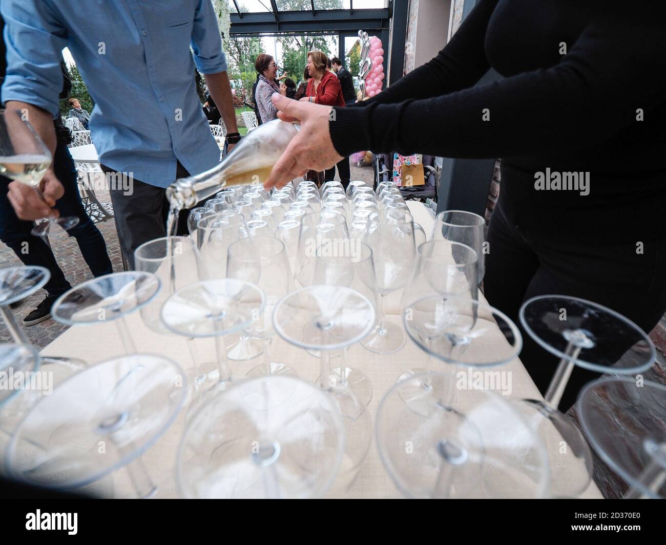 People and catering staff wearing face mask for covid protection at a ...