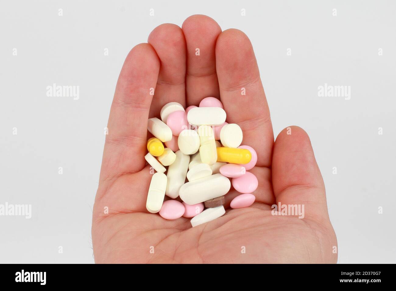 different medical tablets in the palm of your hand Stock Photo - Alamy