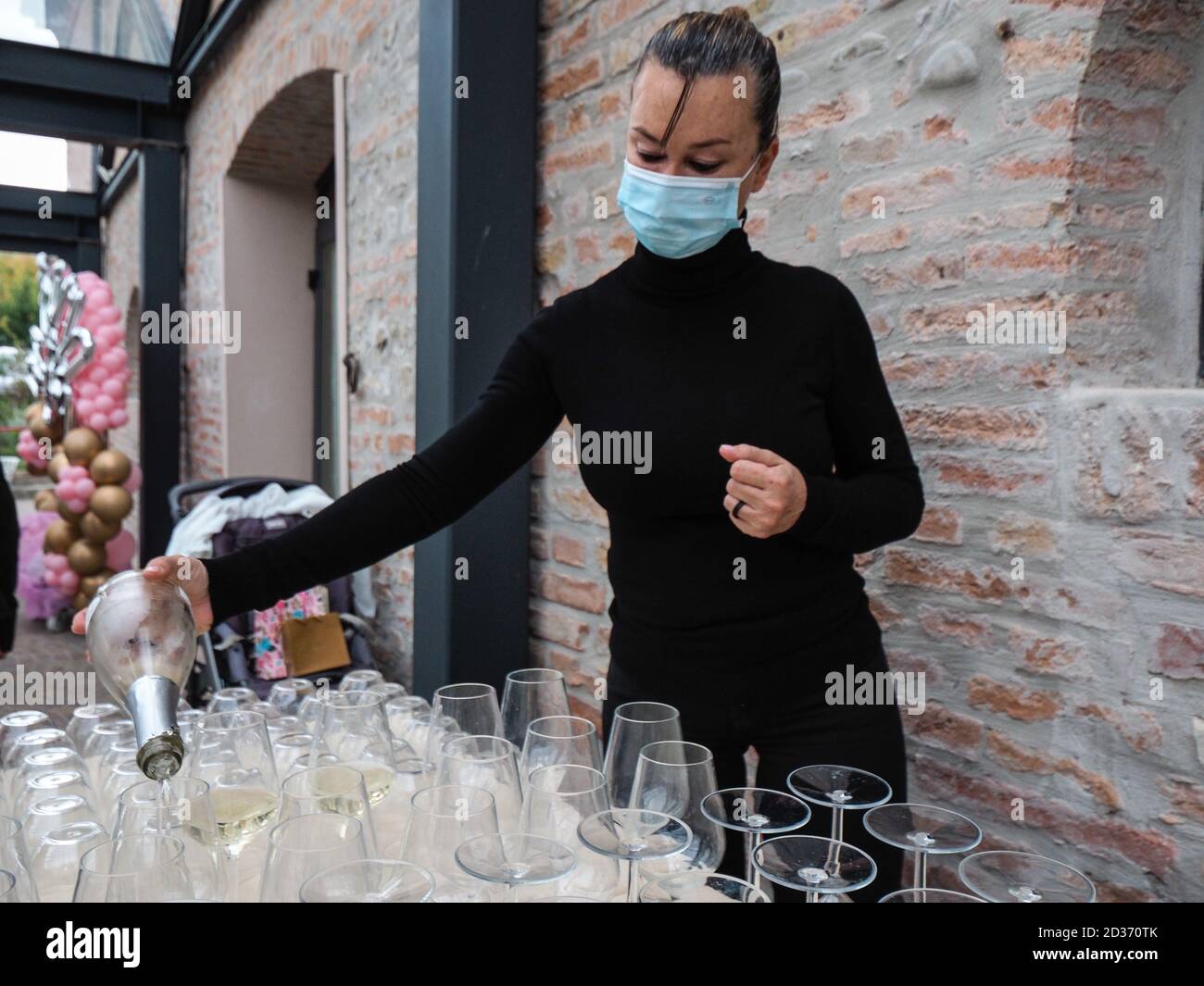 People and catering staff wearing face mask for covid protection at a ...
