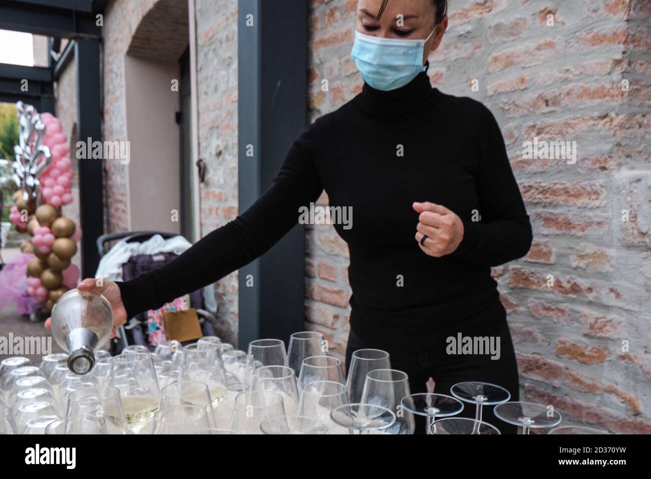 People and catering staff wearing face mask for covid protection at a ...
