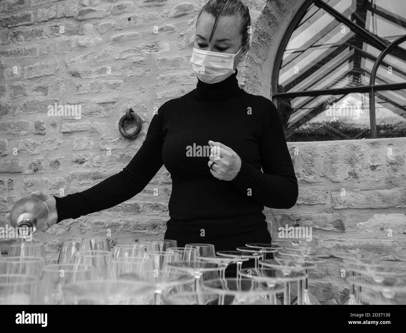 People and catering staff wearing face mask for covid protection at a ...