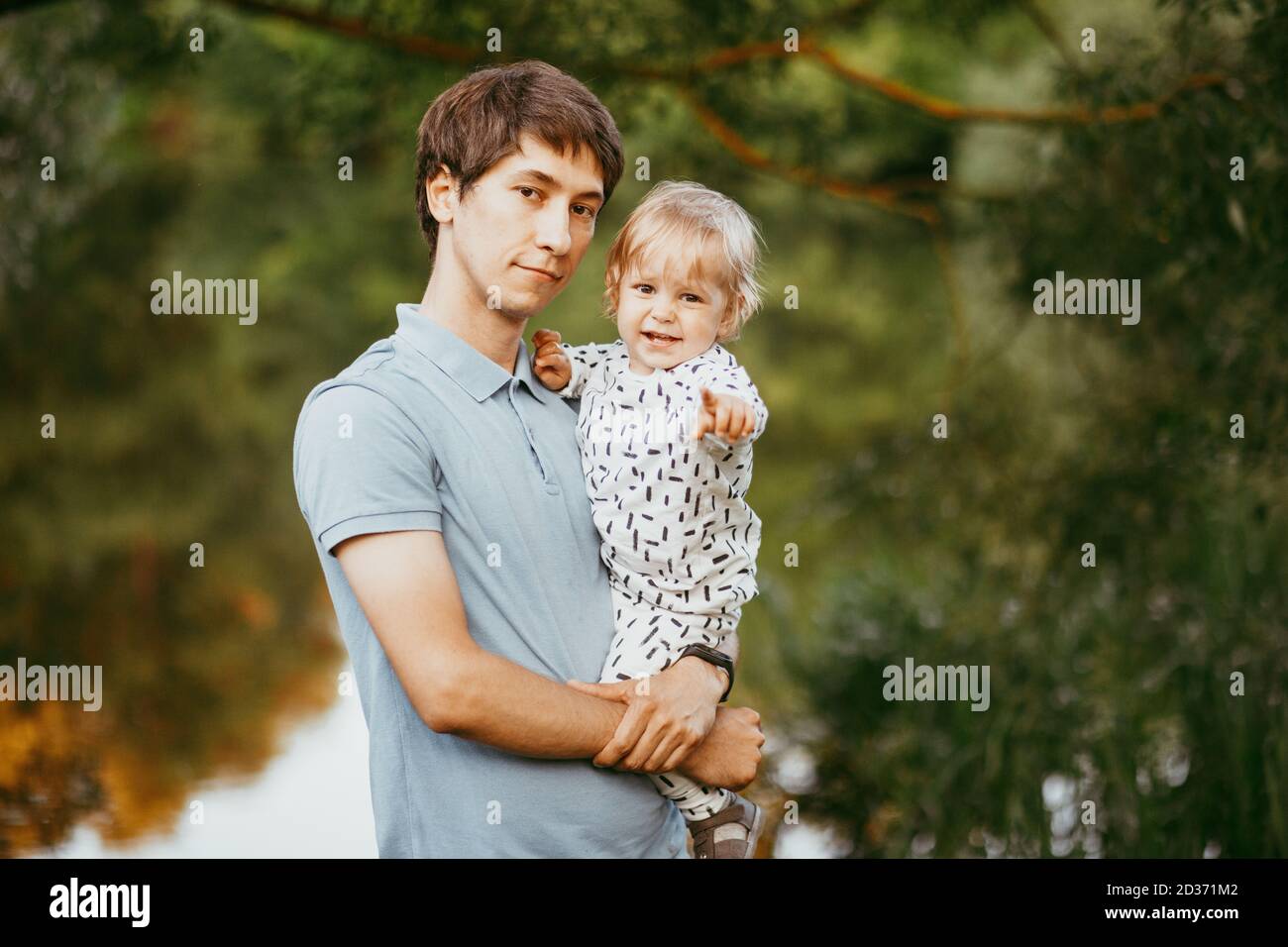 happy family father and son walking in nature Stock Photo - Alamy