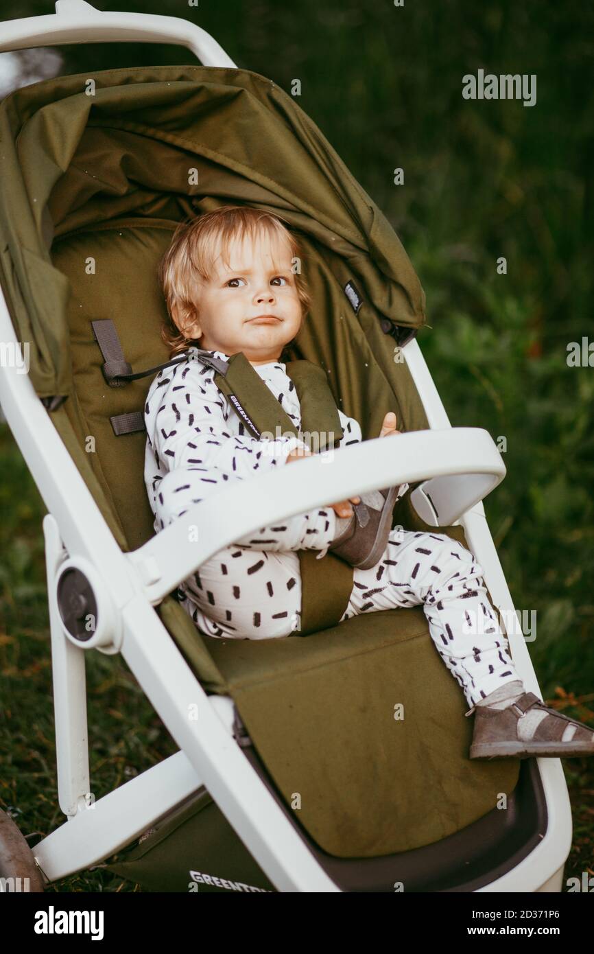 Cute healthy little boy sitting in a stroller and waiting for his ...