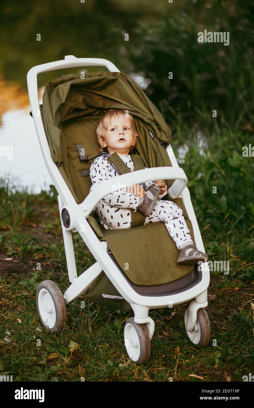 Cute healthy little boy sitting in a stroller and waiting for his ...