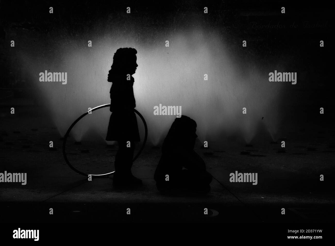 Two children playing with a ring - A urban sculpture Stock Photo - Alamy