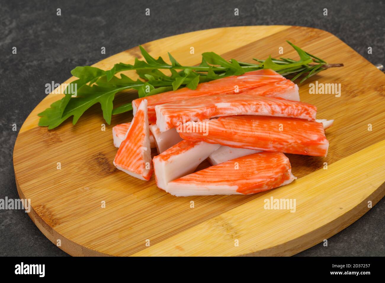 Crab stick surimi over wooden board Stock Photo - Alamy