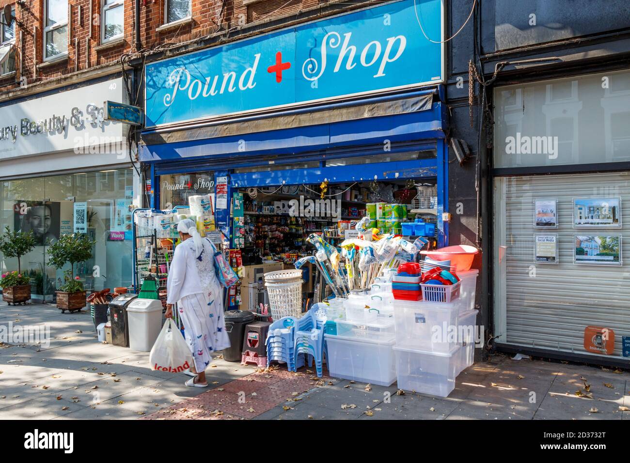 A woman walks past a pound shop on Junction Road, Islington, London, UK ...