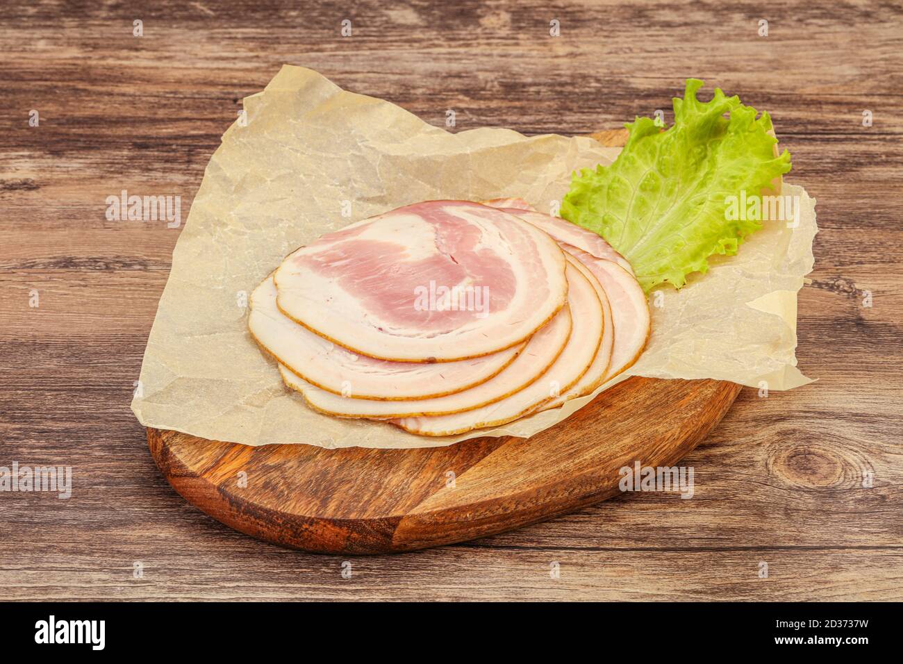 Sliced Italian Pancetta sausage over board Stock Photo - Alamy
