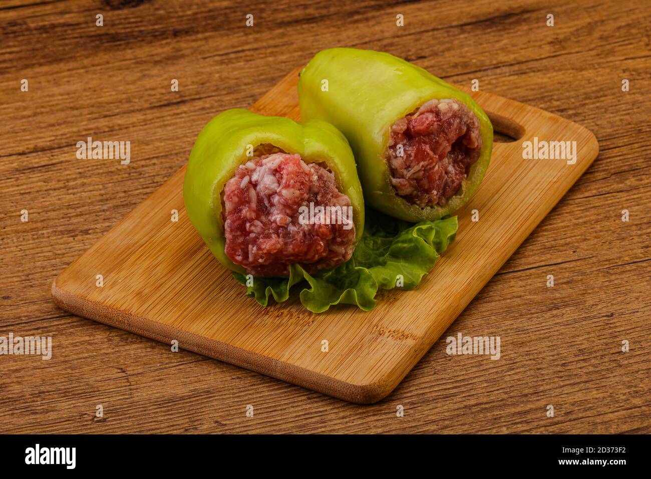 Raw stuffed green bell pepper with meat Stock Photo - Alamy