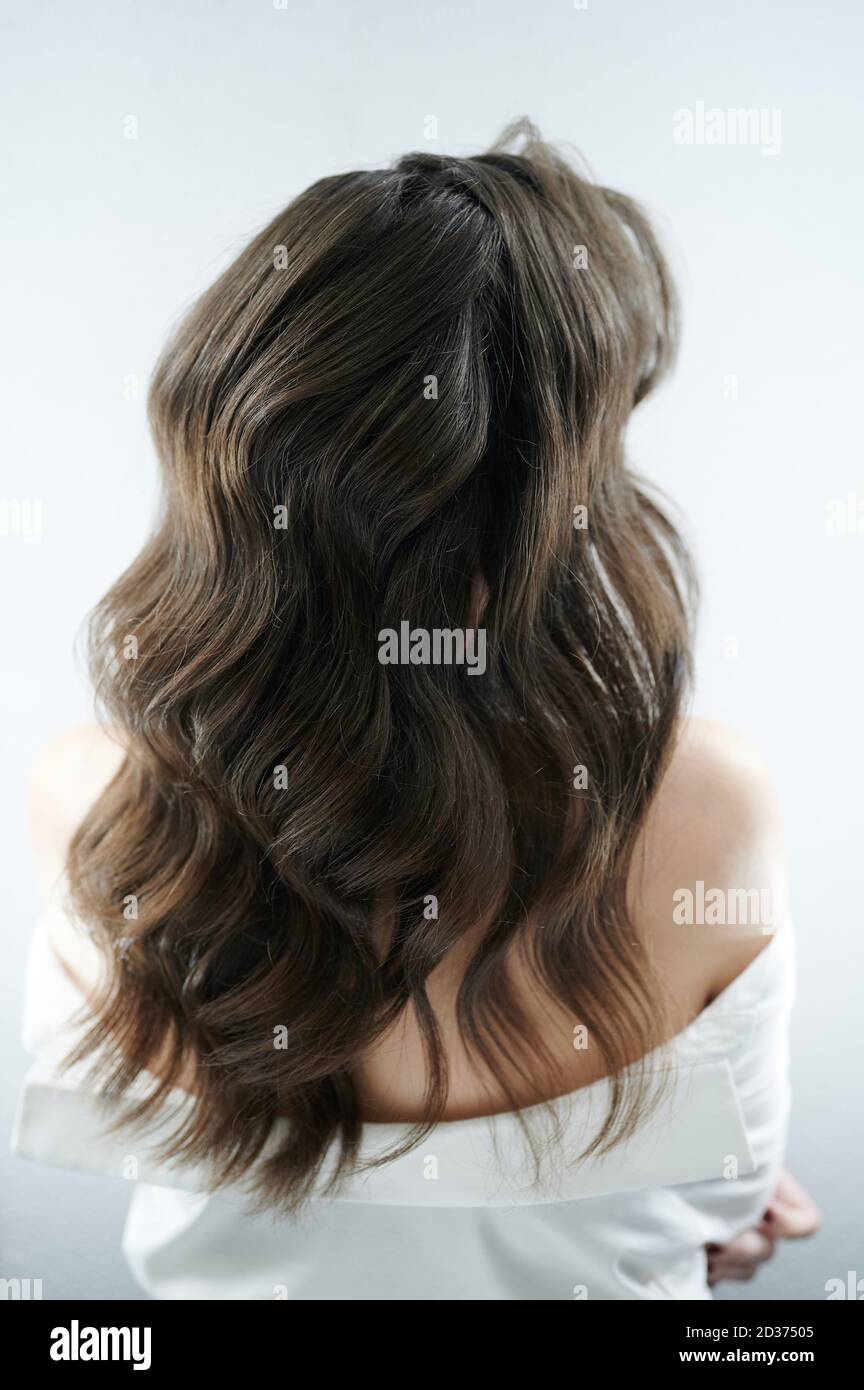 Brunette woman back view on white studio background Stock Photo - Alamy