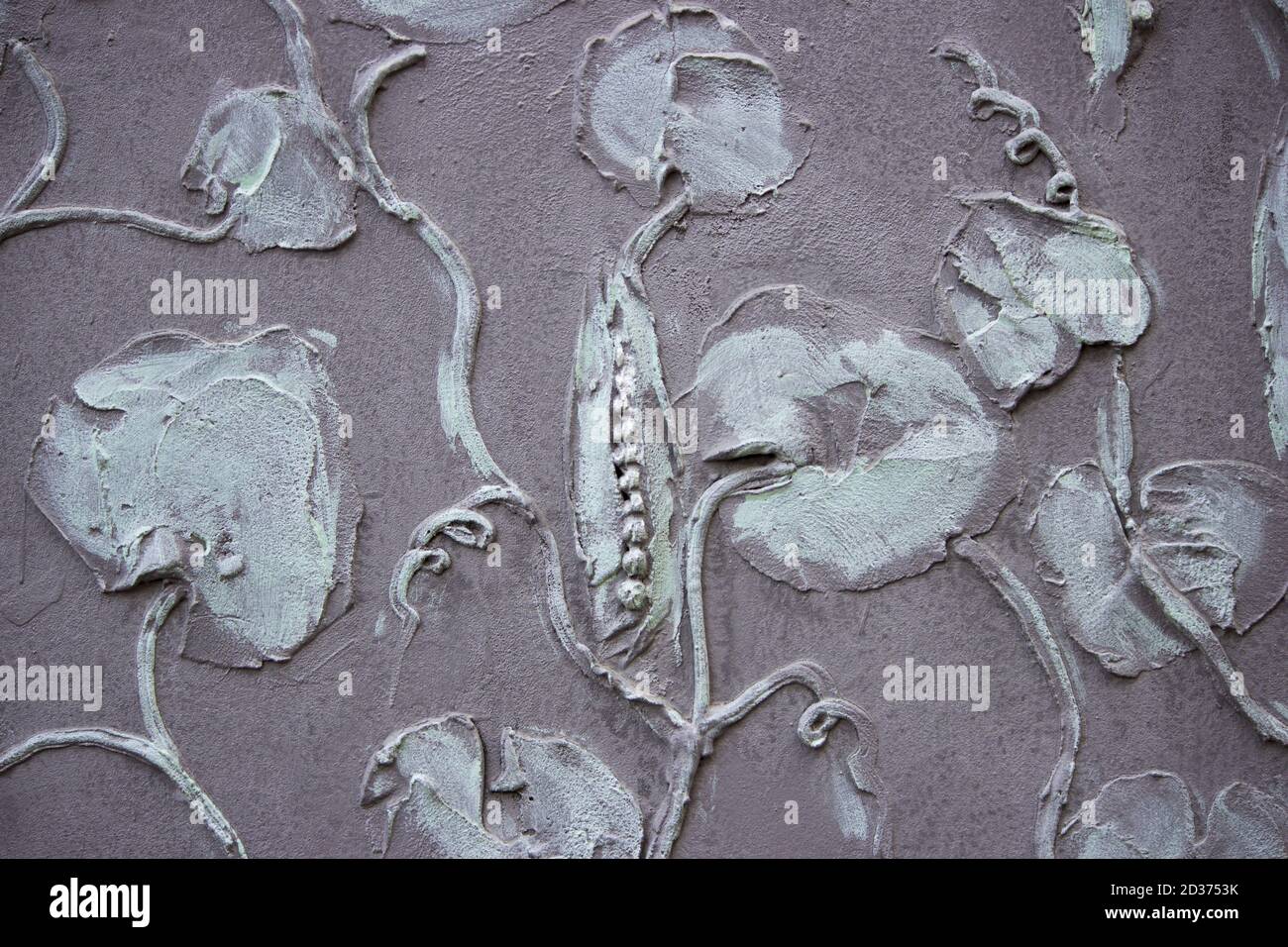 stucco molding of flowers and herbs on the wall of the house. the ...