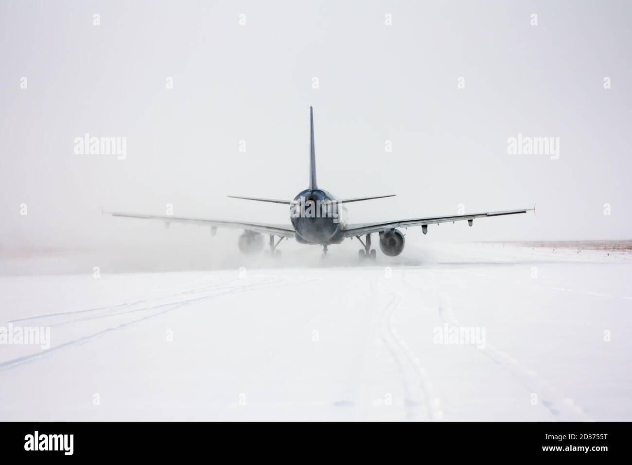 Taxiing passenger aircraft in a snow blizzard Stock Photo - Alamy