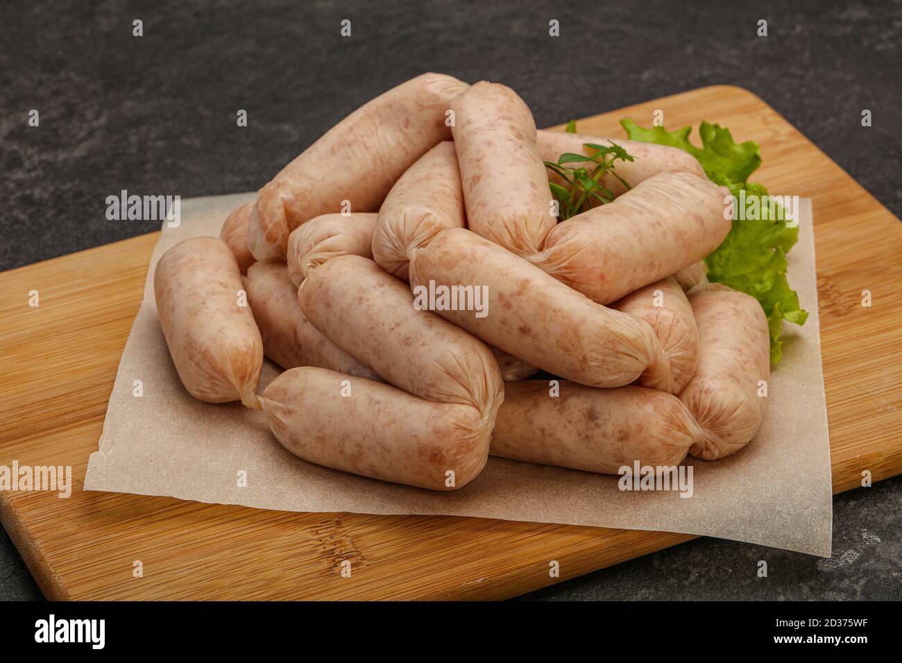Raw natural chicken baby sausages for roast Stock Photo - Alamy