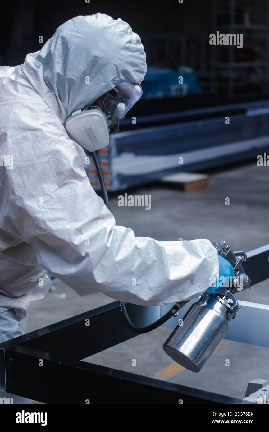 Vertical shot of a person in protective coverall suit and gas ...