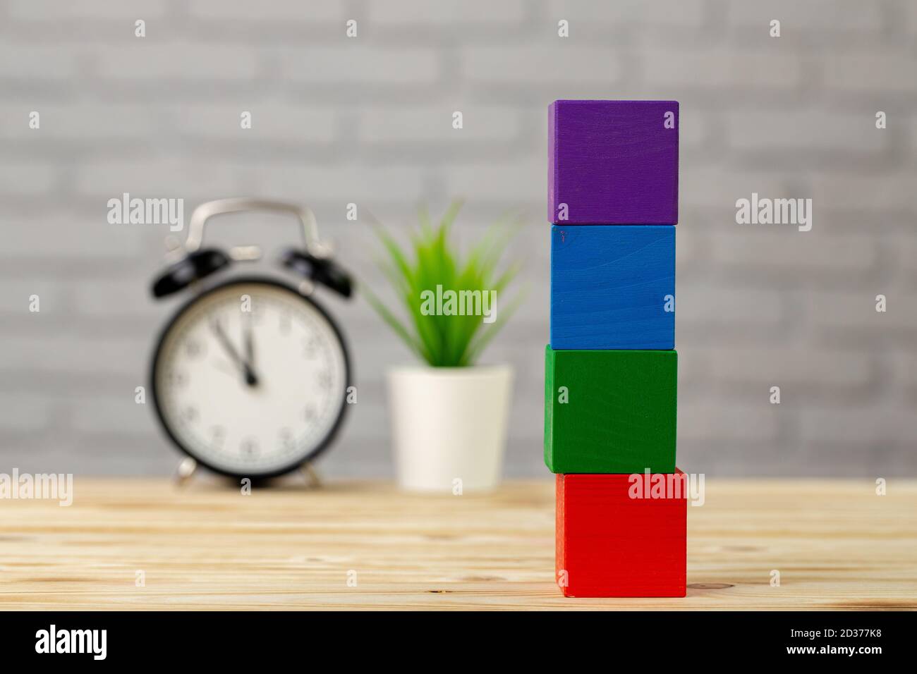 Four wooden cubes with copy space and alarm clock Stock Photo - Alamy