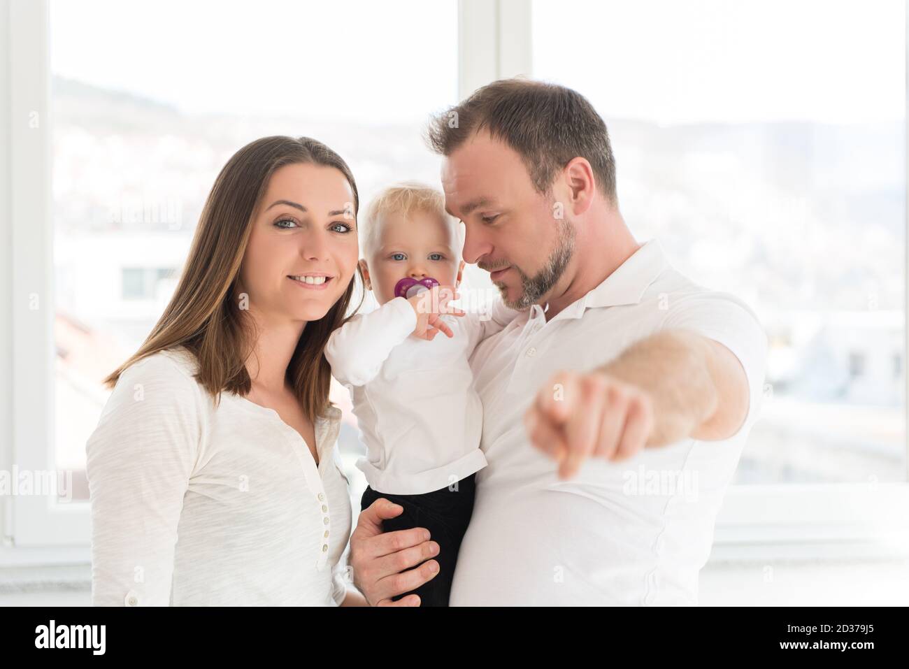 Portrait of happy family of three. Parents with their beautiful baby ...