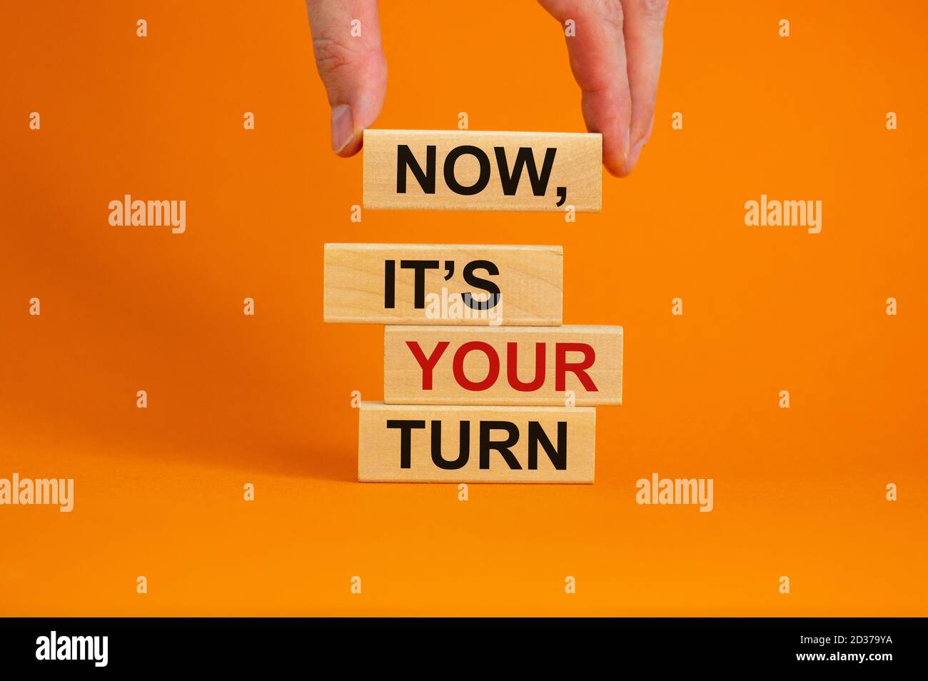 Wooden blocks form the words 'now, it's your turn' on beautiful orange ...
