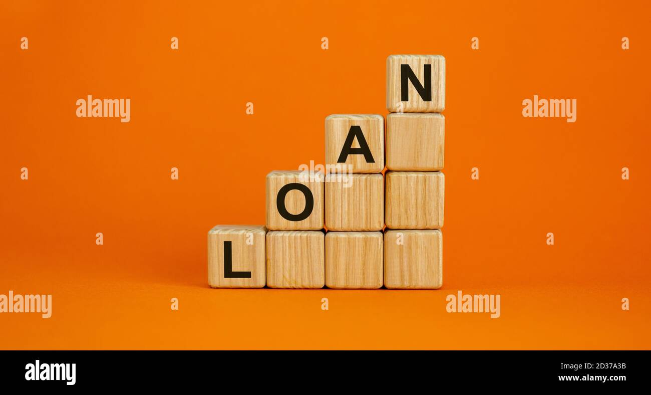 Wood cubes with word 'loan' stacking as step stair on beautiful orange ...