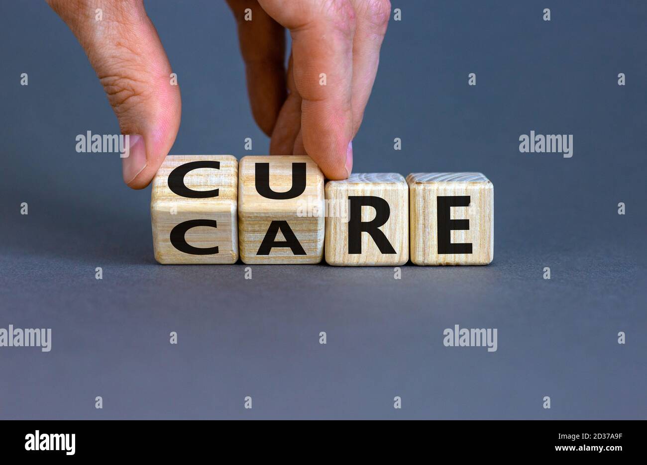 Hand is turning cubes and changes the word 'CARE' to 'CURE'. Beautiful ...