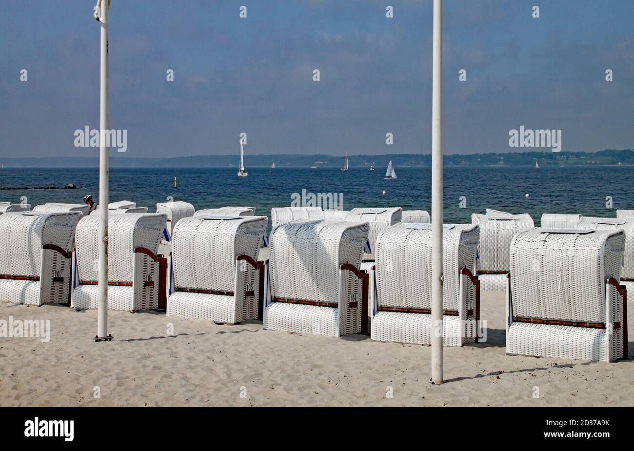 Beach scene with typical hooded windbreak chairs on a quiet beach in ...