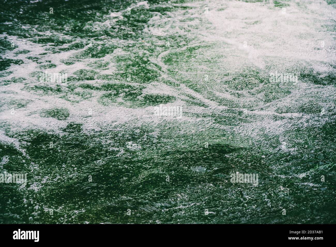 Green water surface with bubbles close-up. Background of green soda ...
