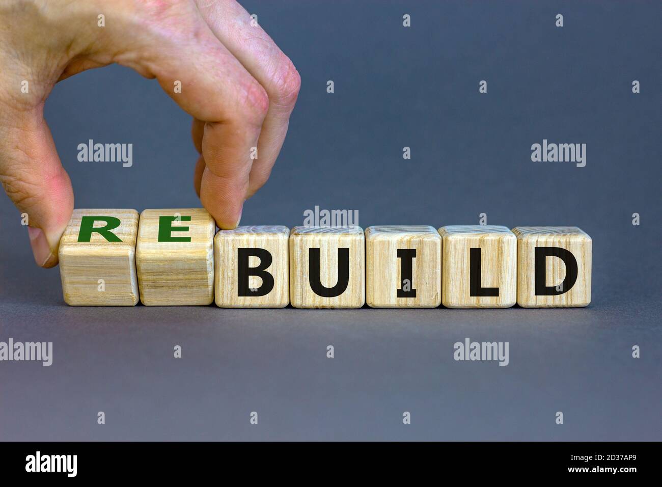 Time to rebuild. Concept words 'build' and 'rebuild' on cubes on a ...